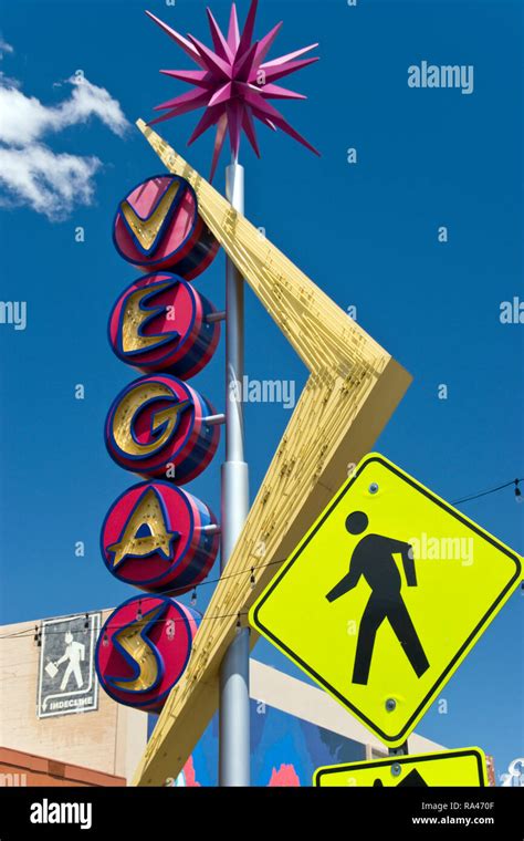 A Pedestrian Walk Sign And Vintage “vegas” Neon Sign In The Fremont