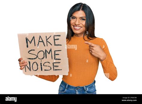 Young Latin Transsexual Transgender Woman Holding Make Some Noise Banner Smiling Happy Pointing