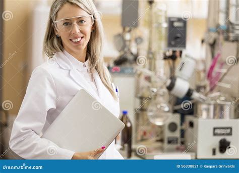 Young Chemist With Laptop Computer Standing In Chemistry Lab Stock