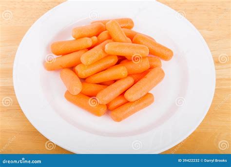 Baby Carrots On White Plate Stock Photo Image Of Plate Nutrition