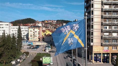 Uzice City And National Serbian Flag Waving On Wind In Downtown On