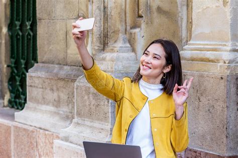 Shot Of A Happy Young Asia Woman Taking Selfie With Her Cellphone