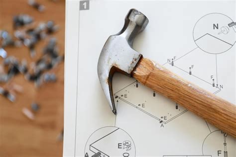 Premium Photo A Hammer With Instructions On How To Assemble A Gray