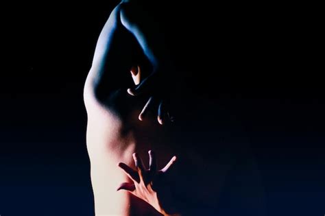 Premium Photo Rear View Of Shirtless Man With Hands Behind Back Standing In Darkroom