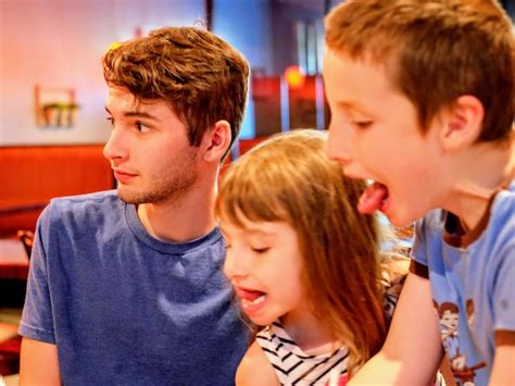 Premium Photo Playful Siblings At Restaurant