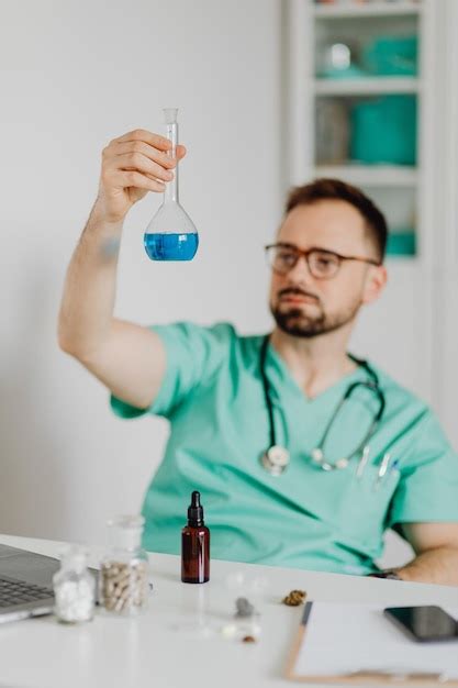 Premium Photo Scientist Examining Sample In Beaker In Laboratory