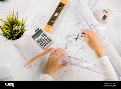 Architect Drawing With Divider Compass On House Plan Blueprint Paper