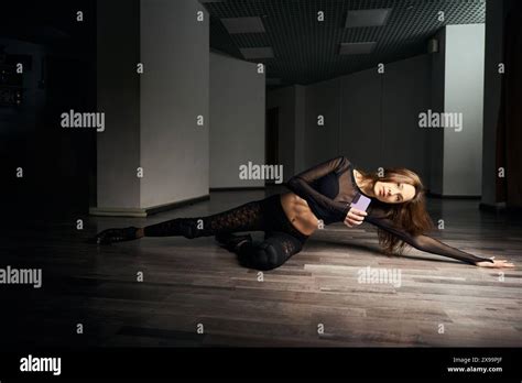 Choreographer In High Heels And Black Attire Practicing Floorwork Moves