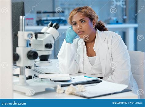 Dreaming Her Life Away A Young Woman Looking Bored While At Work In