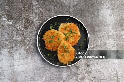 Rustic Hash Browns With Chives On A Round Plate On A Dark Background