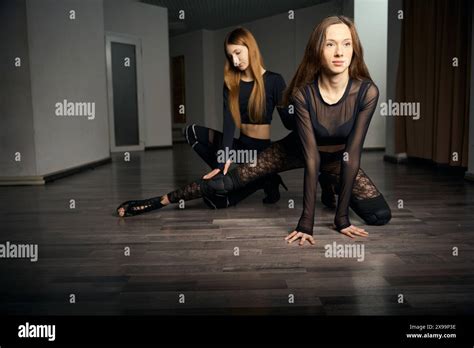 Female Dancer Doing Leg Stretch Before Stiletto Dance Assisted By Instructor Stock Photo Alamy