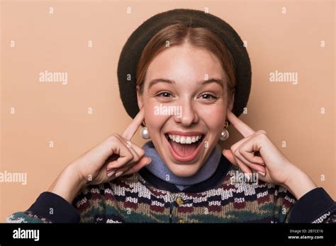 Photo Of Pretty Excited Woman In Earrings Plugging Her Ears And