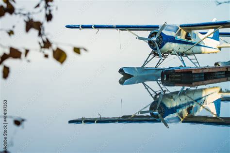 Beautiful Reflection Of A Vintage Float Plane With Fog In The
