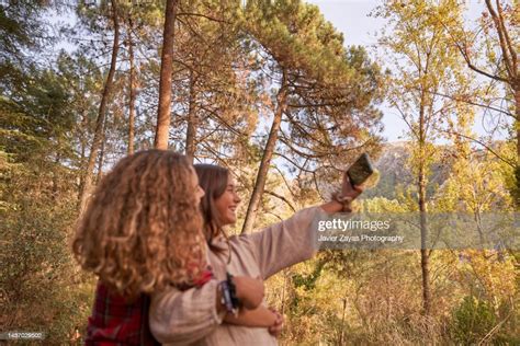 Two Defocused Girls Taking Selfies In The Forest Photo Getty Images
