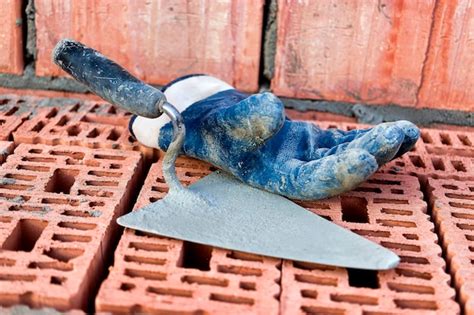 Premium Photo Construction Tool For Laying Bricks And Blocks Bricklayers Tools Hammer Spatula