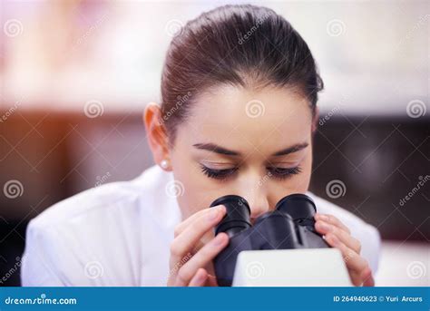 Microbiologists See Everything A Young Scientist Using A Microscope In