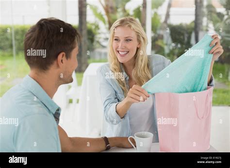 Pretty Blonde Showing Her Boyfriend Her New Clothes Stock Photo Alamy