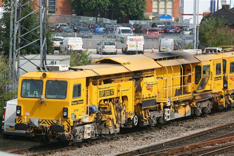 A Yellow Train Is Sitting On The Tracks