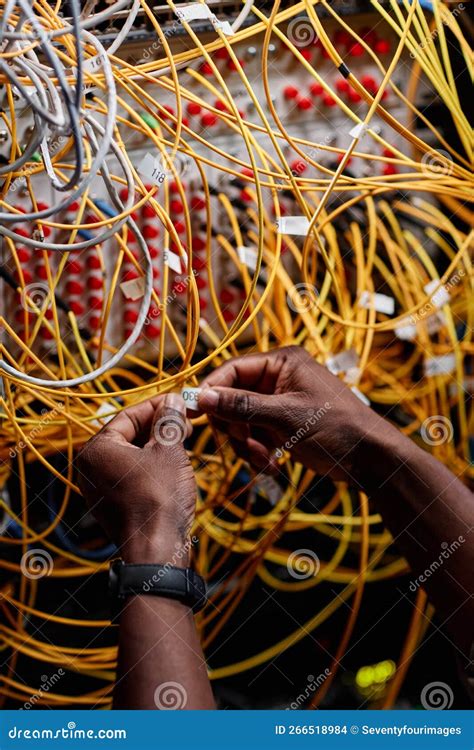 Male Hands Connecting Cables And Wires In Server Room While Setting Up Network Stock Photo