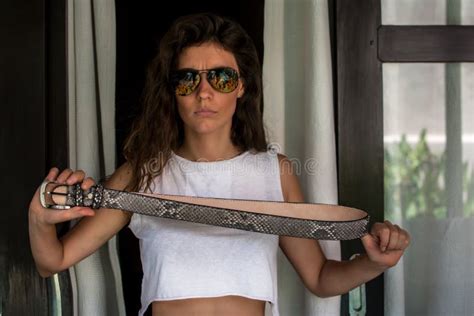Angry Girl With Belt In Hand Evil Girl Holds A Strap Of Python Firy
