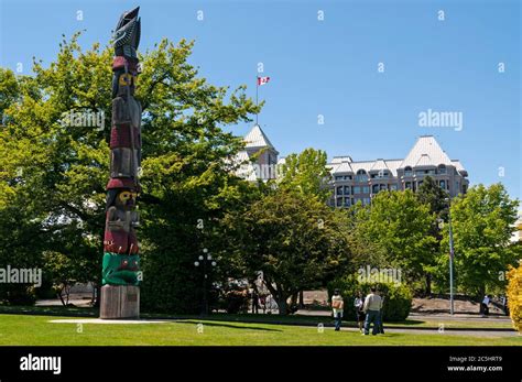 A First Nation Totem Pole A Hand Carved Decorated Wooden Pole In The Grounds Of The Legislative