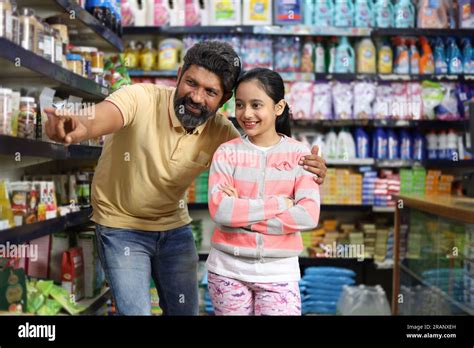Happy Father With Daughter Purchasing In Grocery Store Buying Grocery