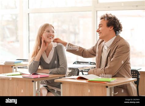 Teenage Babe Fixing His Girlfriend S Hair In Classroom Stock Photo Alamy