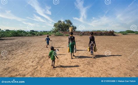 Unidentified Woman From Dassanech Tribe Carrying Water To Her Village
