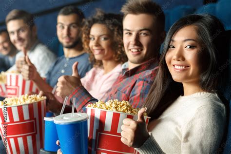 Stock Foto „cinema Fans All Here Group Of Cheerful Friends Showing