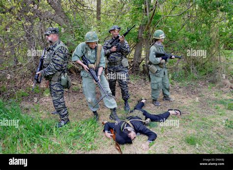 Us Soldiers Stand Over A Dead Viet Cong Soldier In A Reenactment Of The