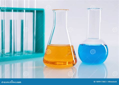 Closeup Shot Of An Erlenmeyer Flask With Orange Liquid And A Round