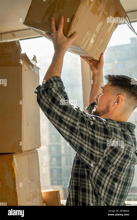 Man Stacking Boxes On Each Other At Home Stock Photo Alamy