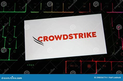 Closeup Of Mobile Phone On Computer Keyboard With Logo Lettering Of