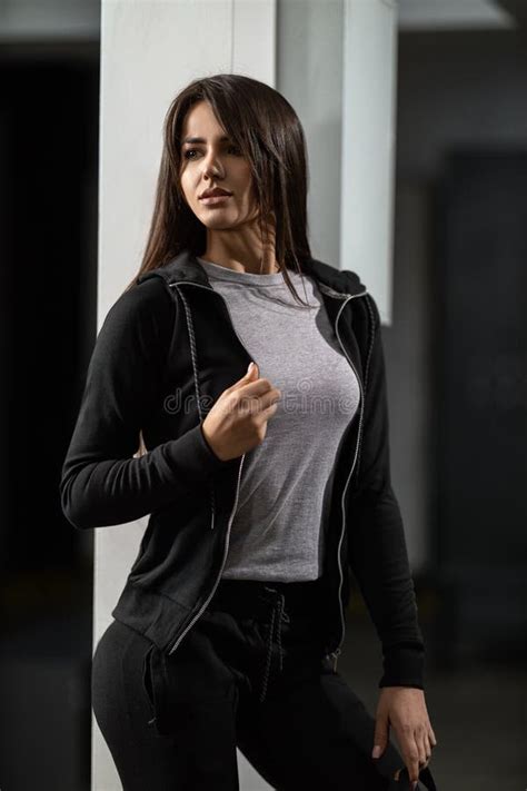 Beautiful Fit Brunette Girl In A Black Tracksuit Holding A Sports