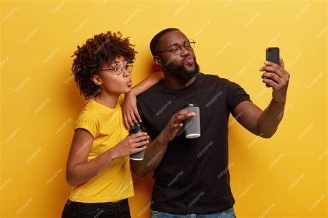 Free Photo Funny Dark Skinned Couple Pouts Lips At Camera Of Cell