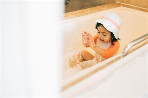 Premium Photo Rear View Of Girl Playing Water In Bathroom