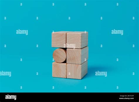A Cylindrical Building Block In A Stack Of Rectangular Building Blocks On A Blue Background