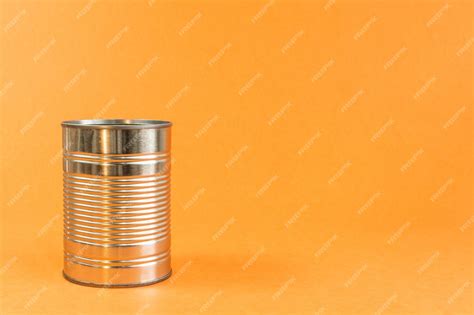 Premium Photo Empty Tin Isolated On An Orange Background Recycling