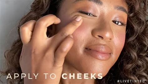 Applying UNITY BALM GLOSS