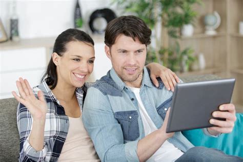 Happy Couple Sitting On Couch At Home Stock Image Image Of Phone