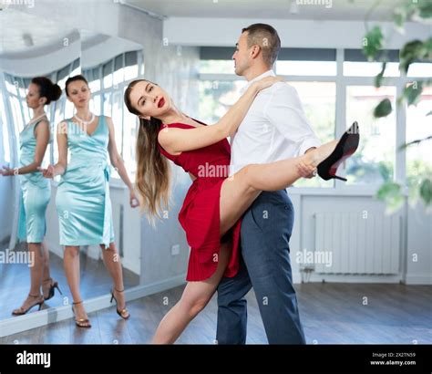 Couple In Stage Costumes Learns Tango Dancing During Individual Lesson