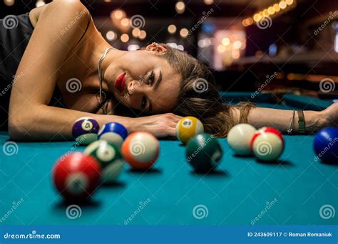 Female Pool Player Wear Black Dress Lying On Billiard Table Stock Image