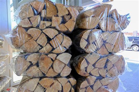 Premium Photo Pile Of Shrink Wrapped Firewood On Display At A Supermarket