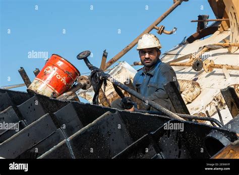 Worker Breaking Up Ship At Gadani Ship Breaking Yard Located Across A