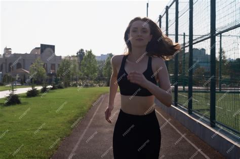 Premium Photo A Woman In Sportswear Works Out At A Sports Stadium Fit