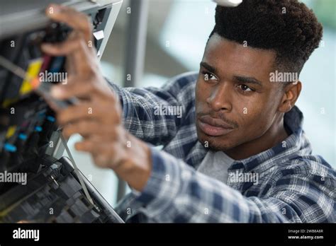 Man Repairing A Professional Photocopier Stock Photo Alamy