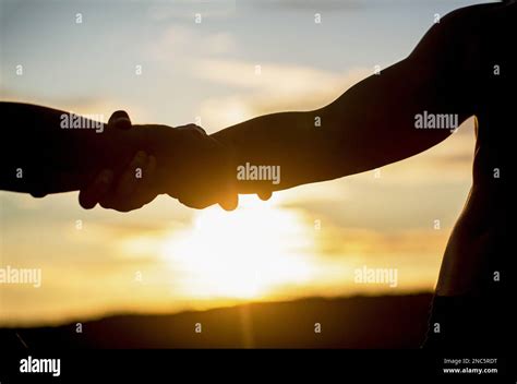 Two Hands Silhouette On Sky Background Connection Or Help Concept