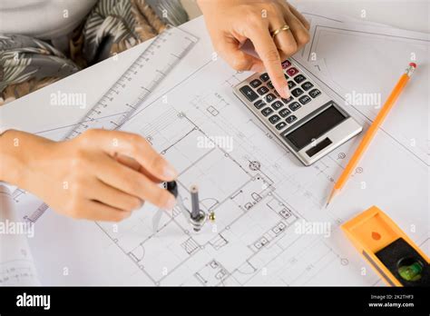 Architect Drawing With Divider Compass On House Plan Blueprint Paper