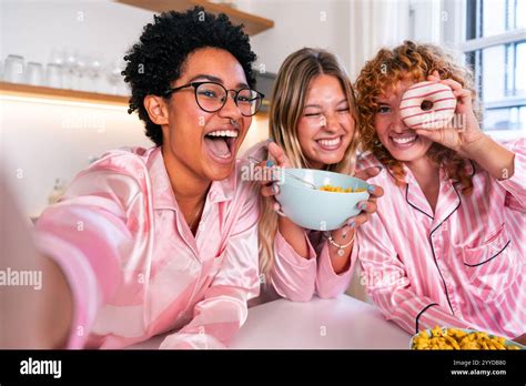 Multiethnic Group Of Young Female Friends Having Breakfast During
