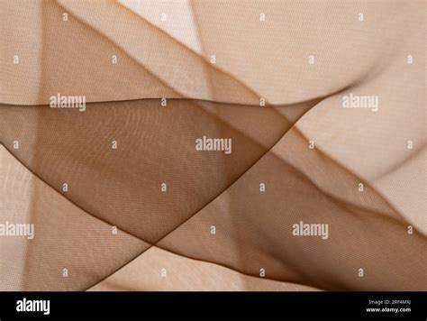 Translucent Fine Material In Beige Brown And Tan Forms Triangular Shapes